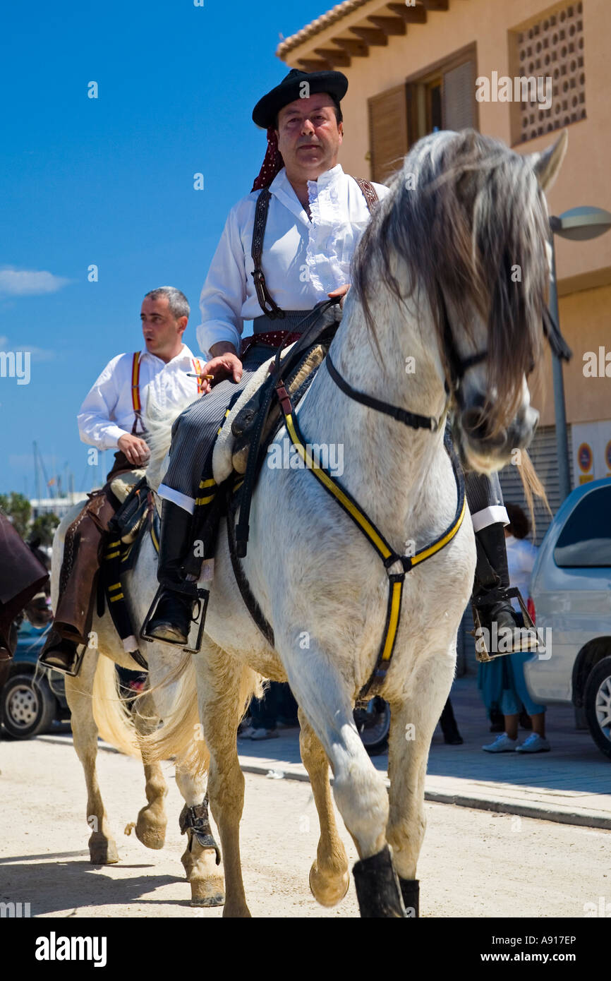 Elegant horseman in traditional spanish costume riding at a local ...