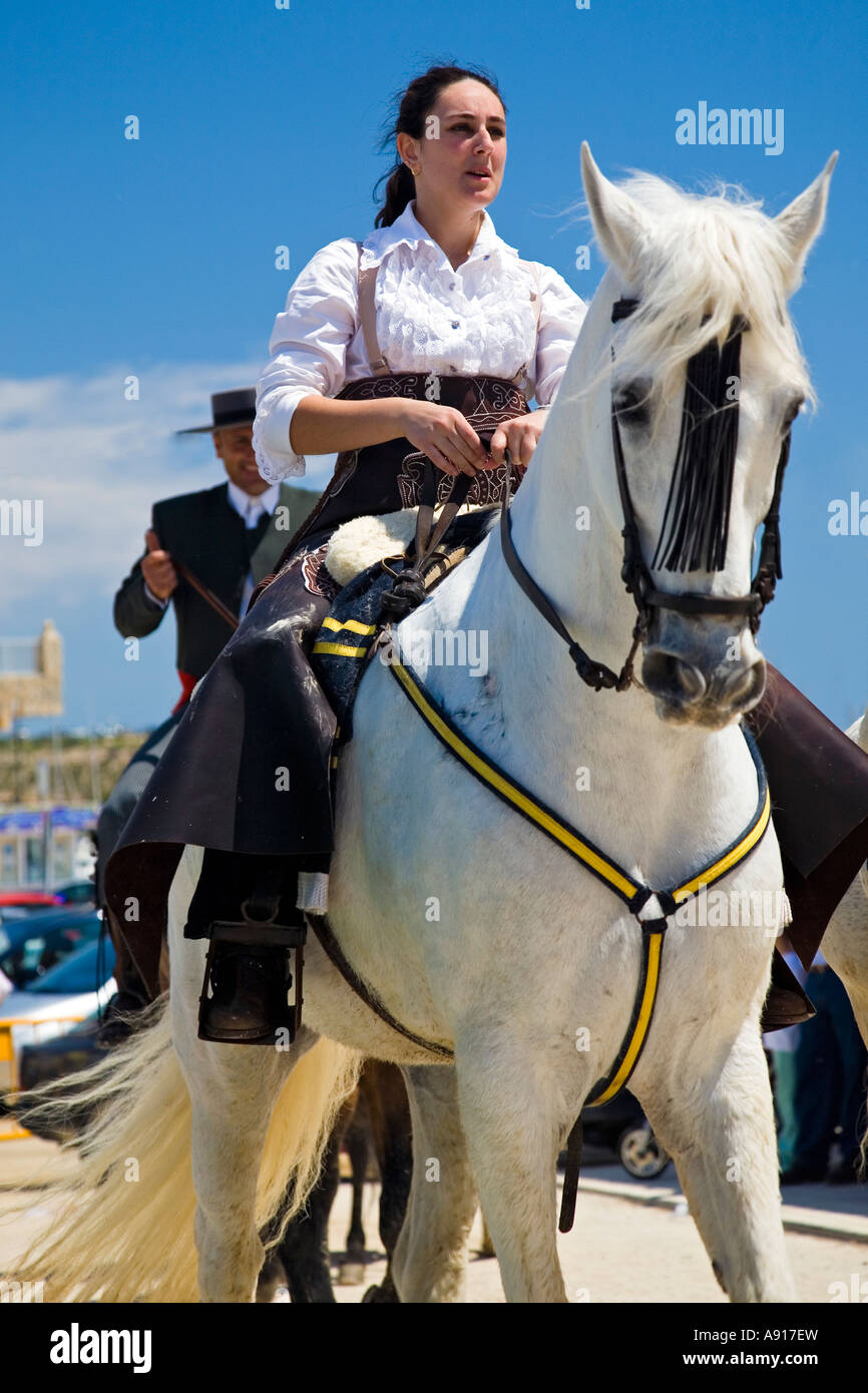 Elegant horsewoman in traditional spanish costume riding at a local ...