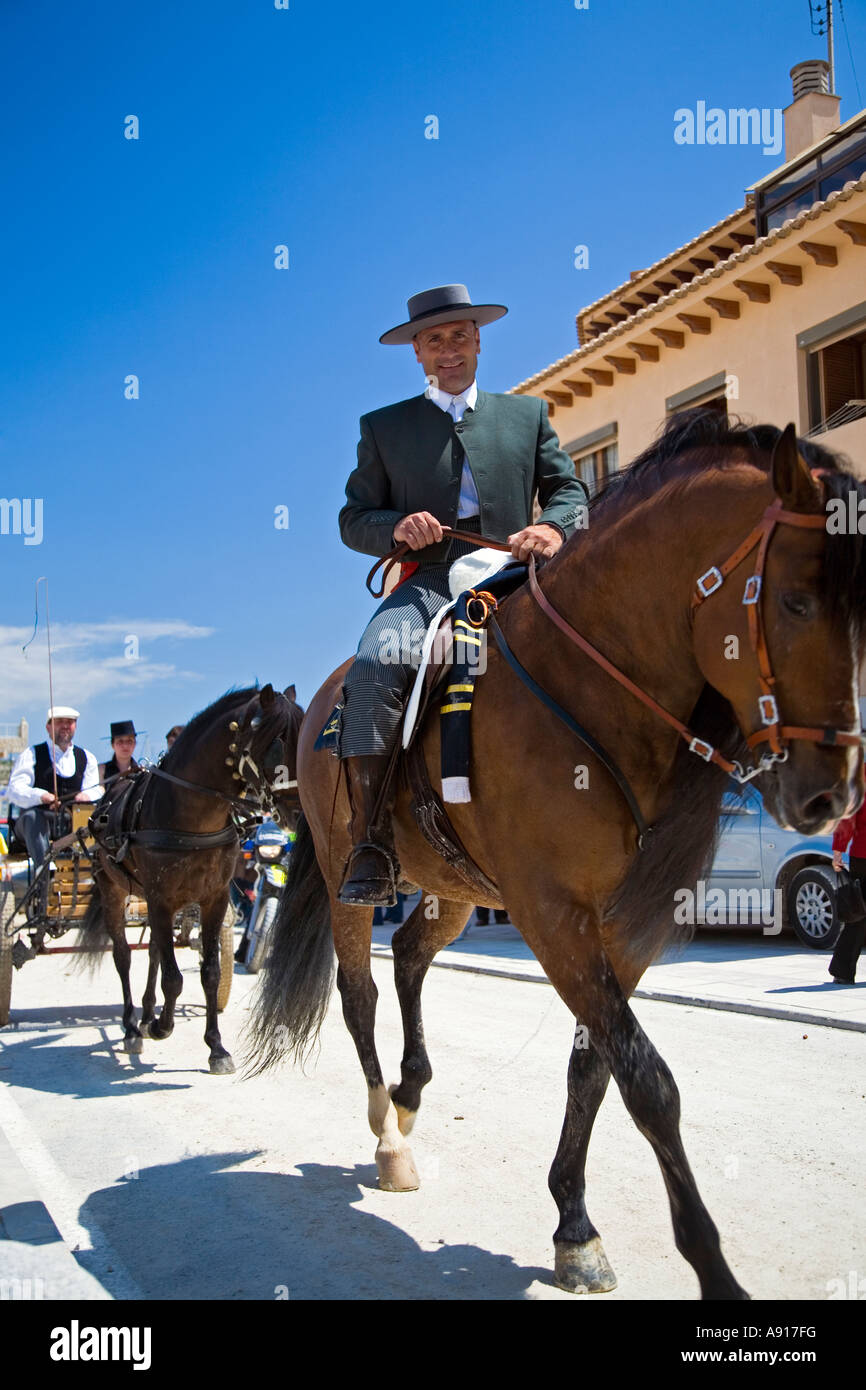 Elegant horseman in traditional spanish costume riding at a local ...