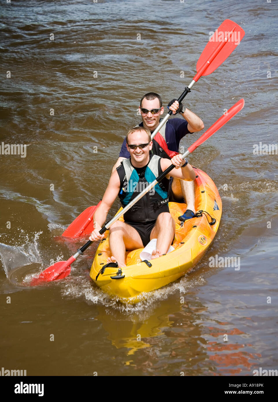 Two men in canoe on canal during adventure race competition Brecon ...