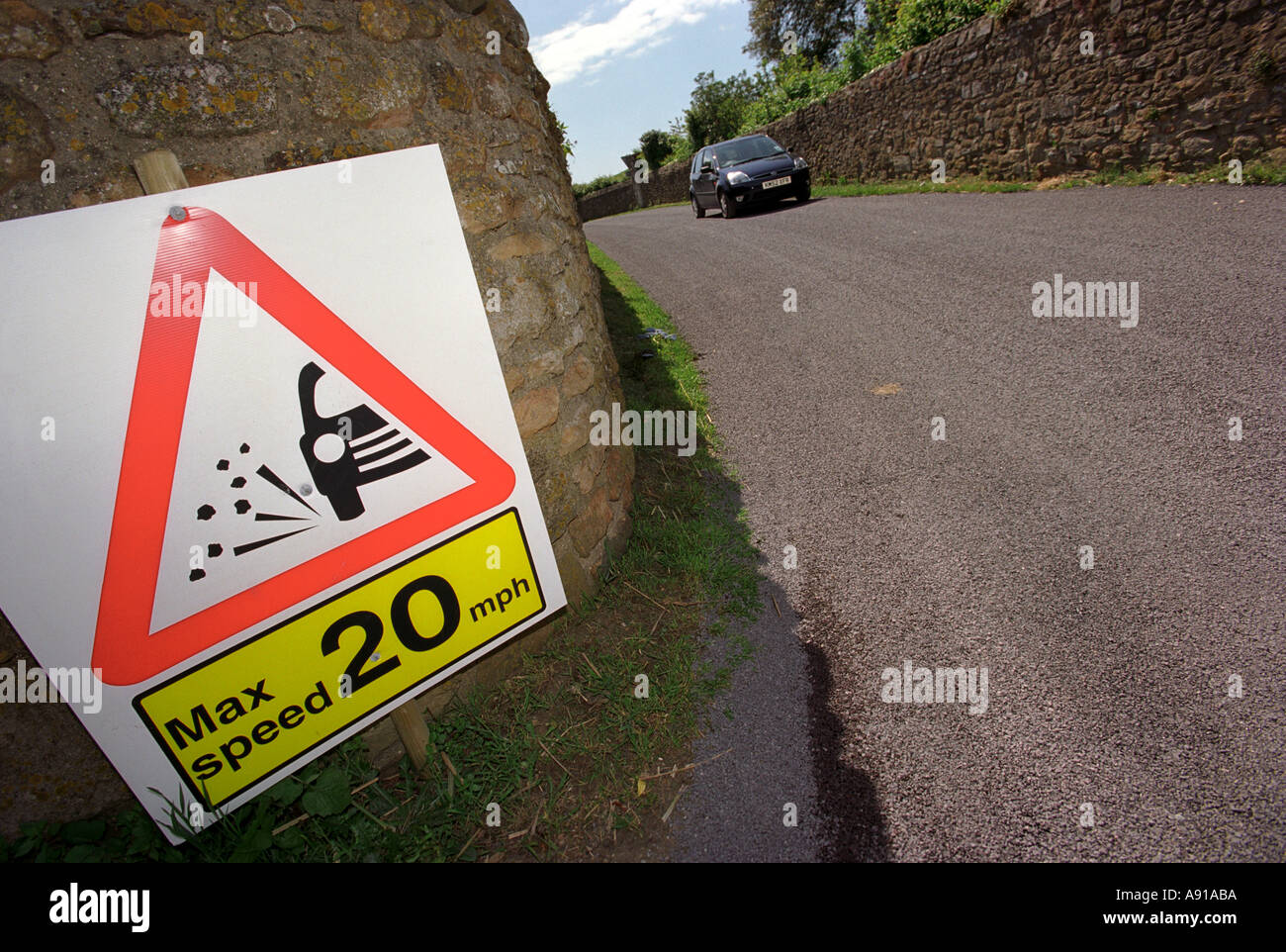 Speed warning sign for loose chippings on a country road in Dorset ...