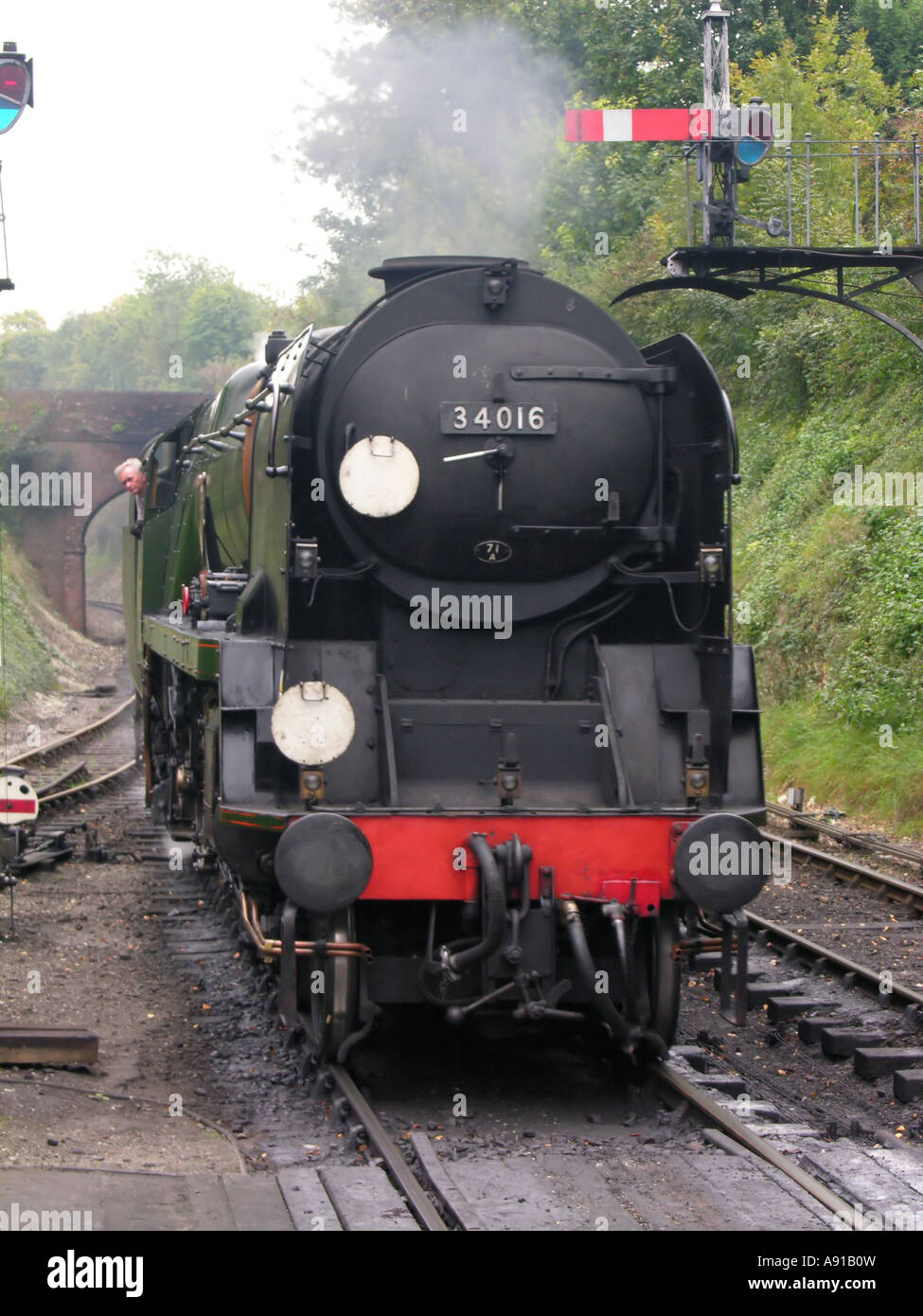 A steam train approaching a station Stock Photo - Alamy