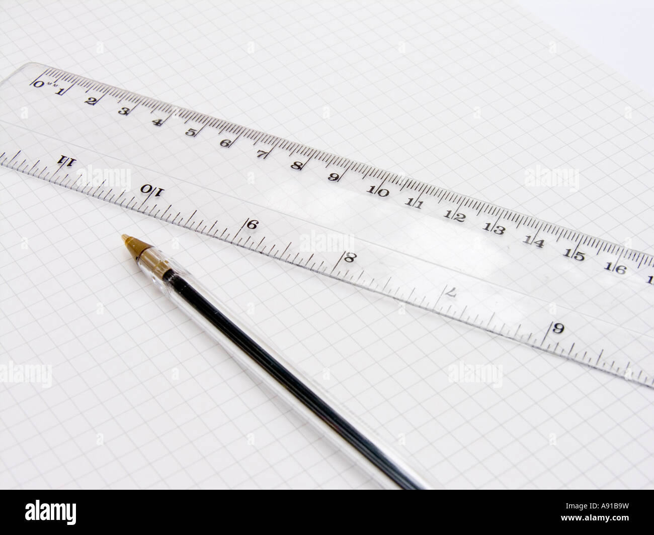 A biro pen and a ruler on squared paper Stock Photo - Alamy