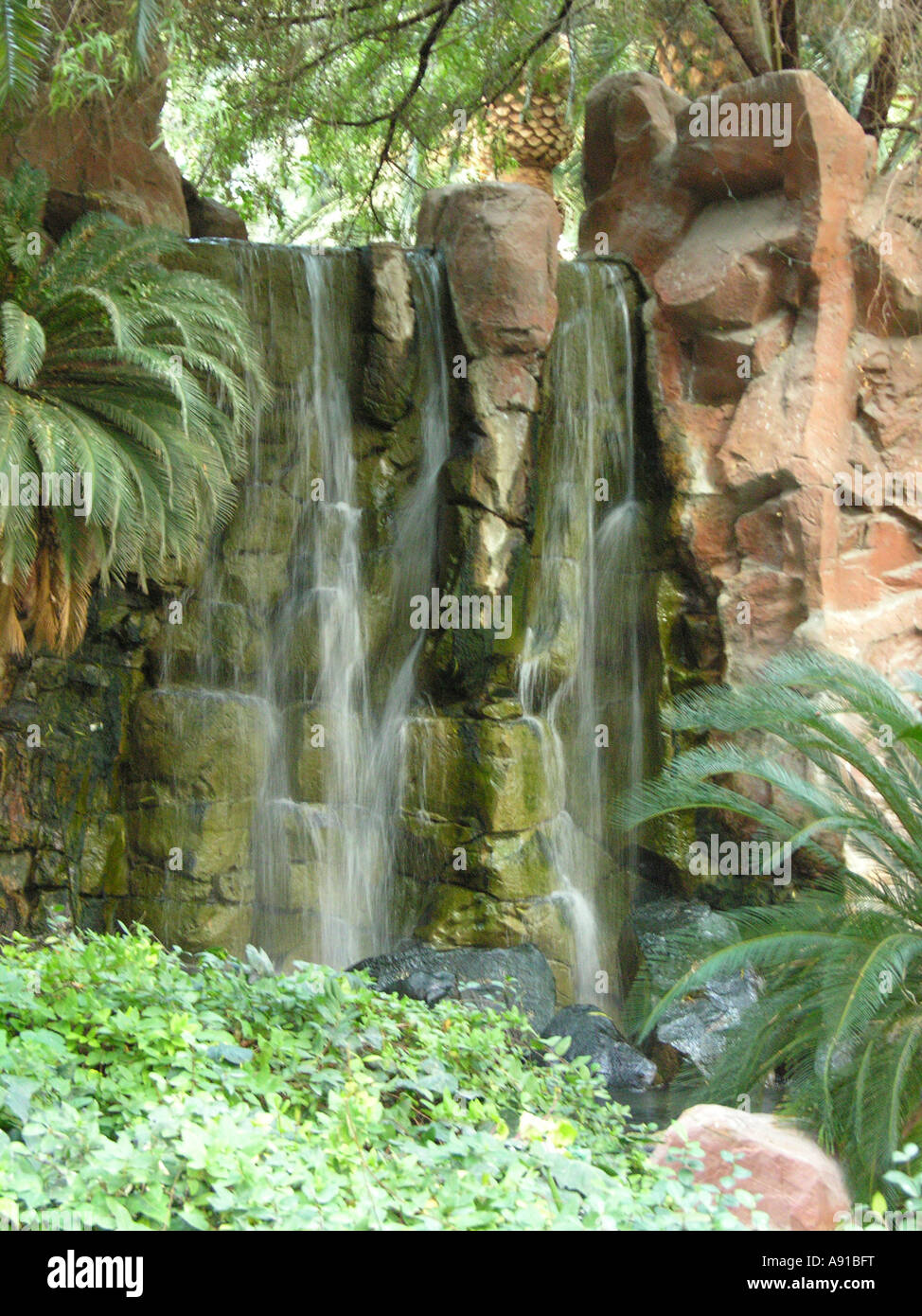 A tropical waterfall in a manmade environment Stock Photo - Alamy