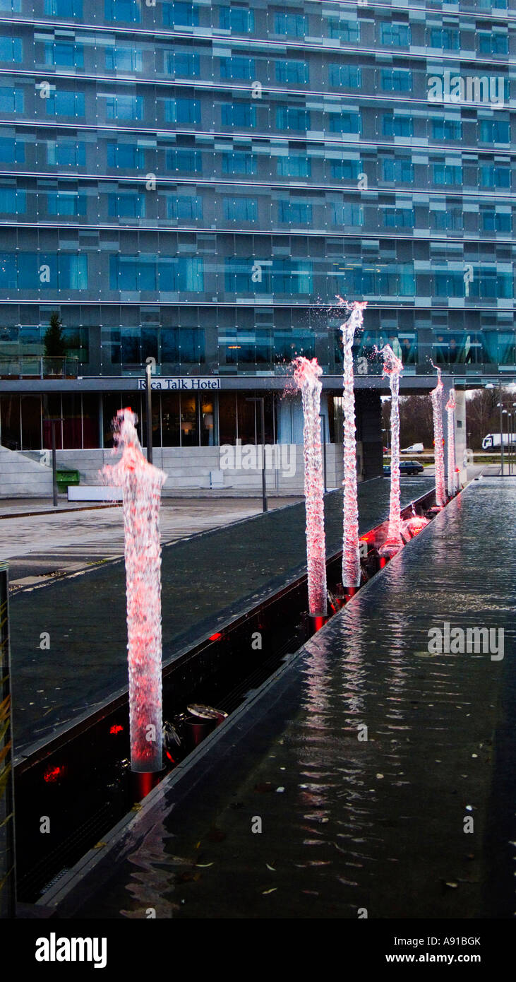 Water sprouts playfully in a fountain outside a new high rise Rica Talk ...