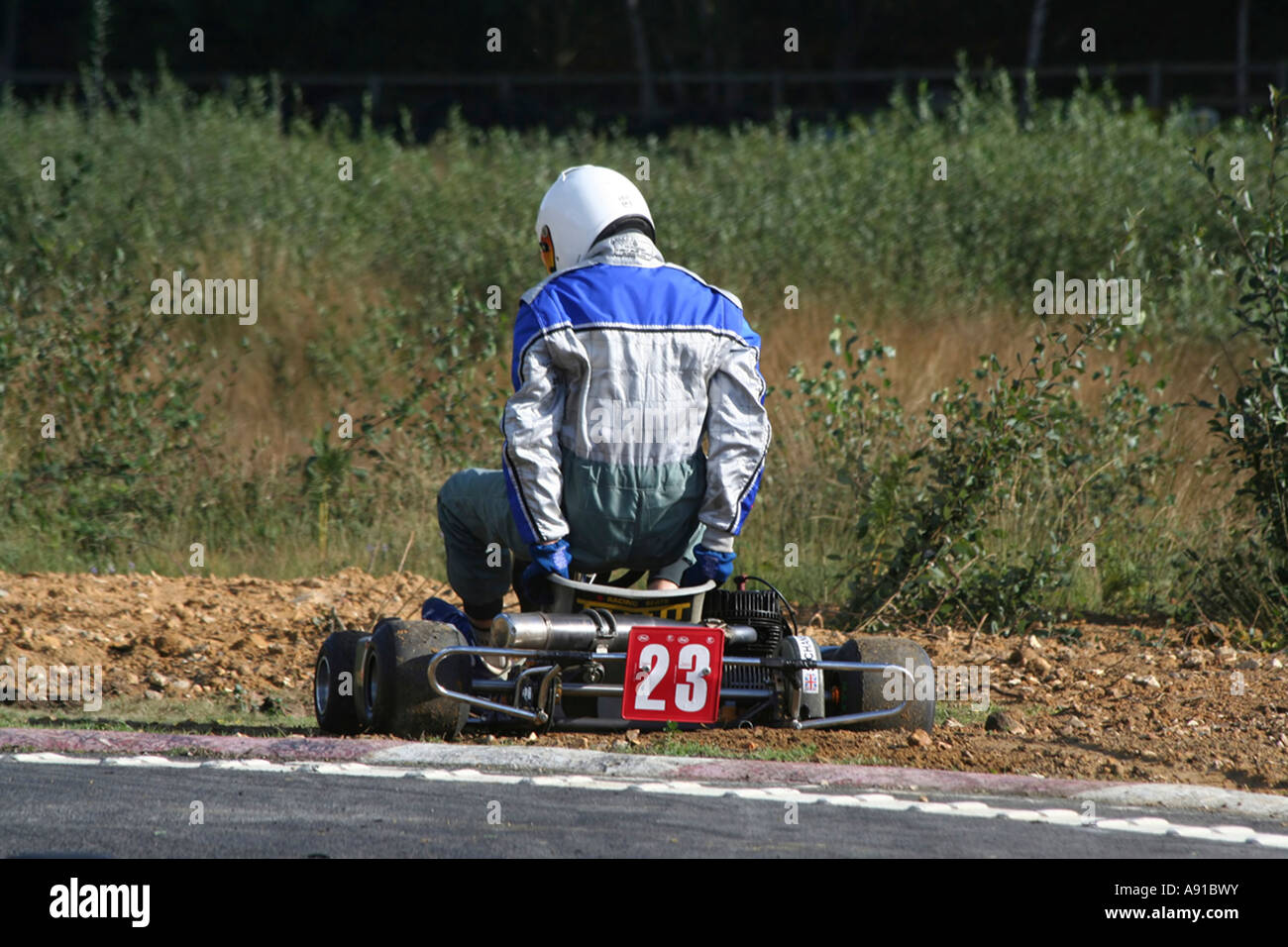 A go kart driver getting out of his kart after breaking down. Karting ...