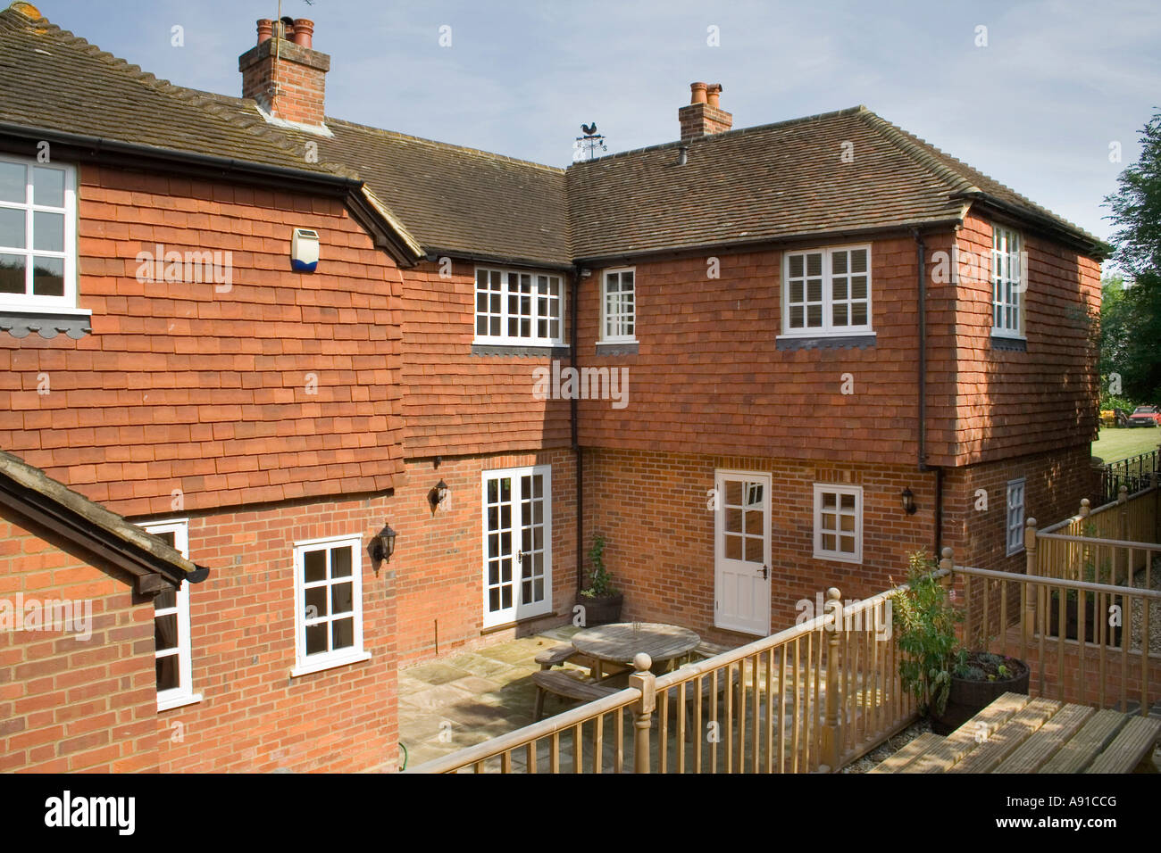 A large house featuring many bricks and tiles Stock Photo - Alamy