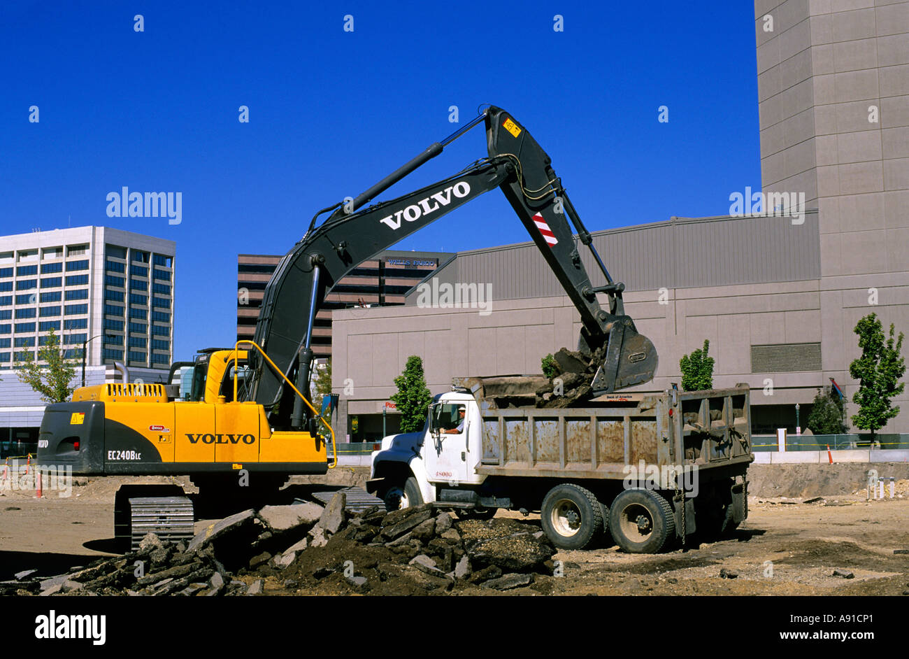Track power shovel and dump truck on a building construction site in ...