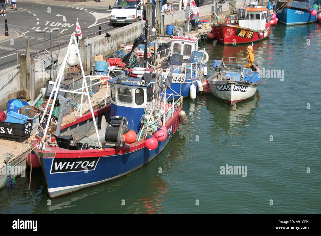 Some fishing boats in a harbour Stock Photo - Alamy