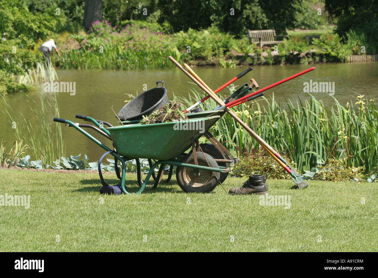 Wheel barrow at garden pond hi-res stock photography and images - Alamy