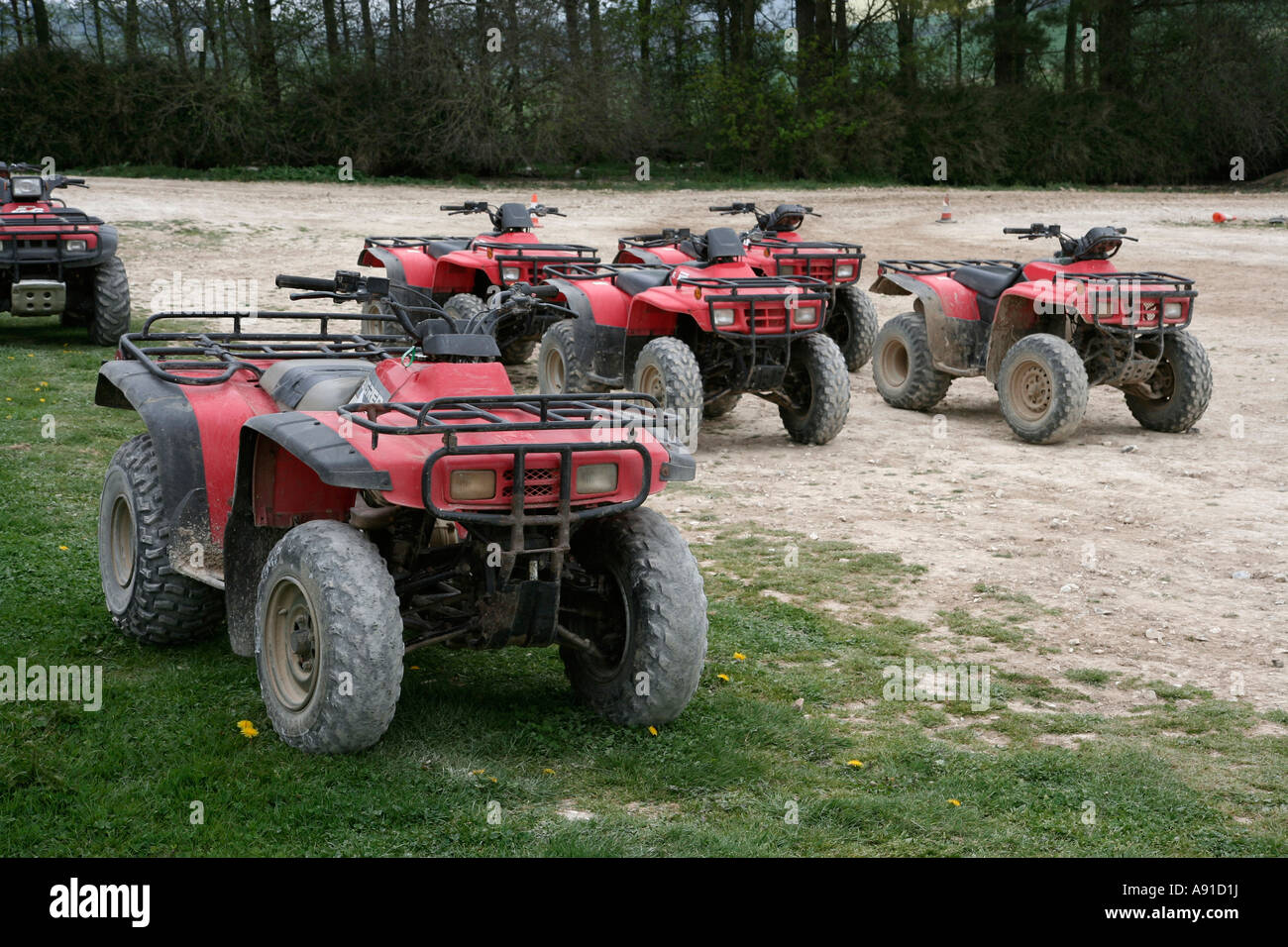 A group of dirty quad bikes waiting to be ridden Stock Photo - Alamy