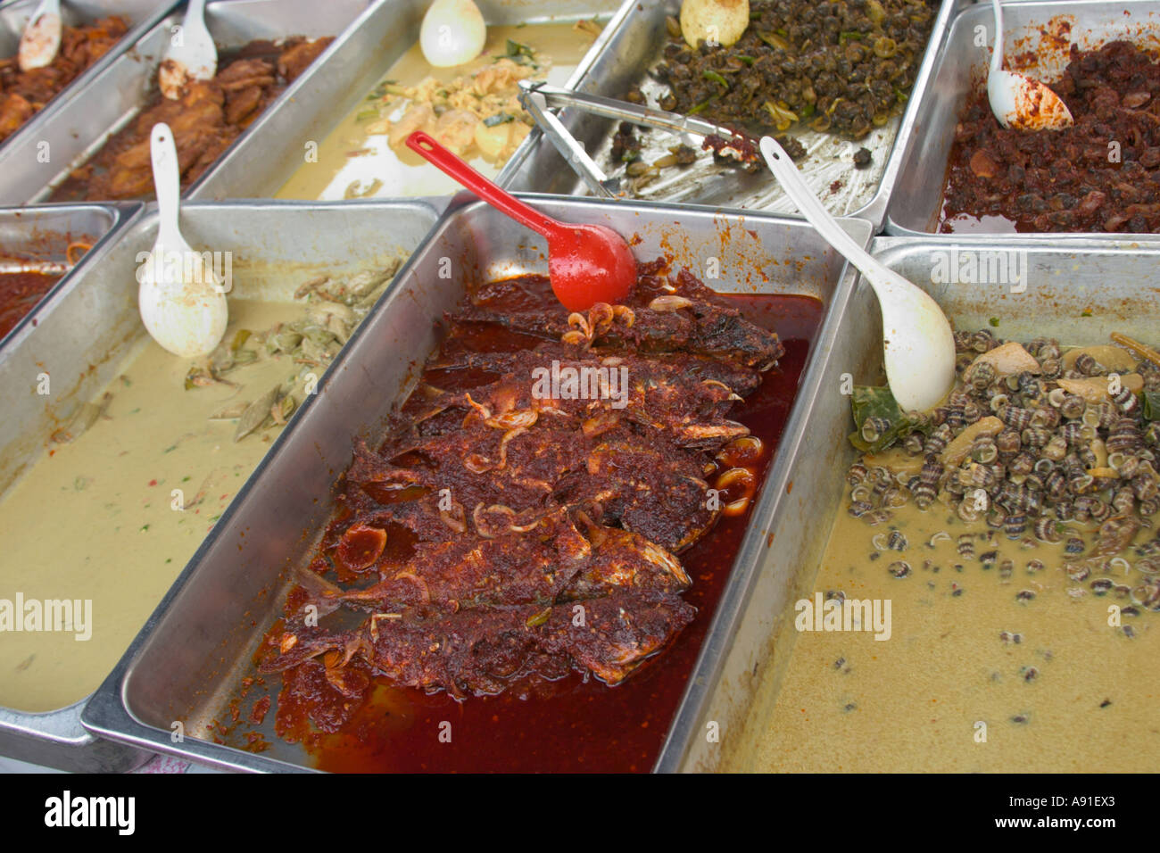 trays of variety of malay food displayed at a hawker stall Stock Photo ...