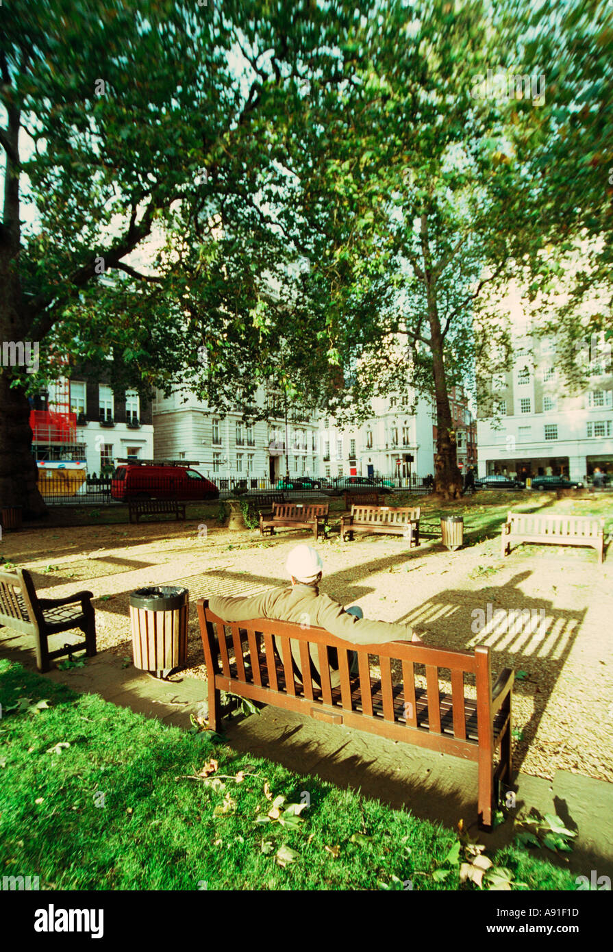 Workman with hard hat relaxing in Berkeley Square London England UK ...