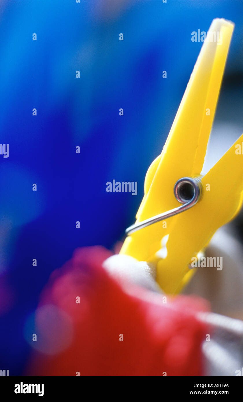 Bright yellow clothes peg on washing line Stock Photo - Alamy