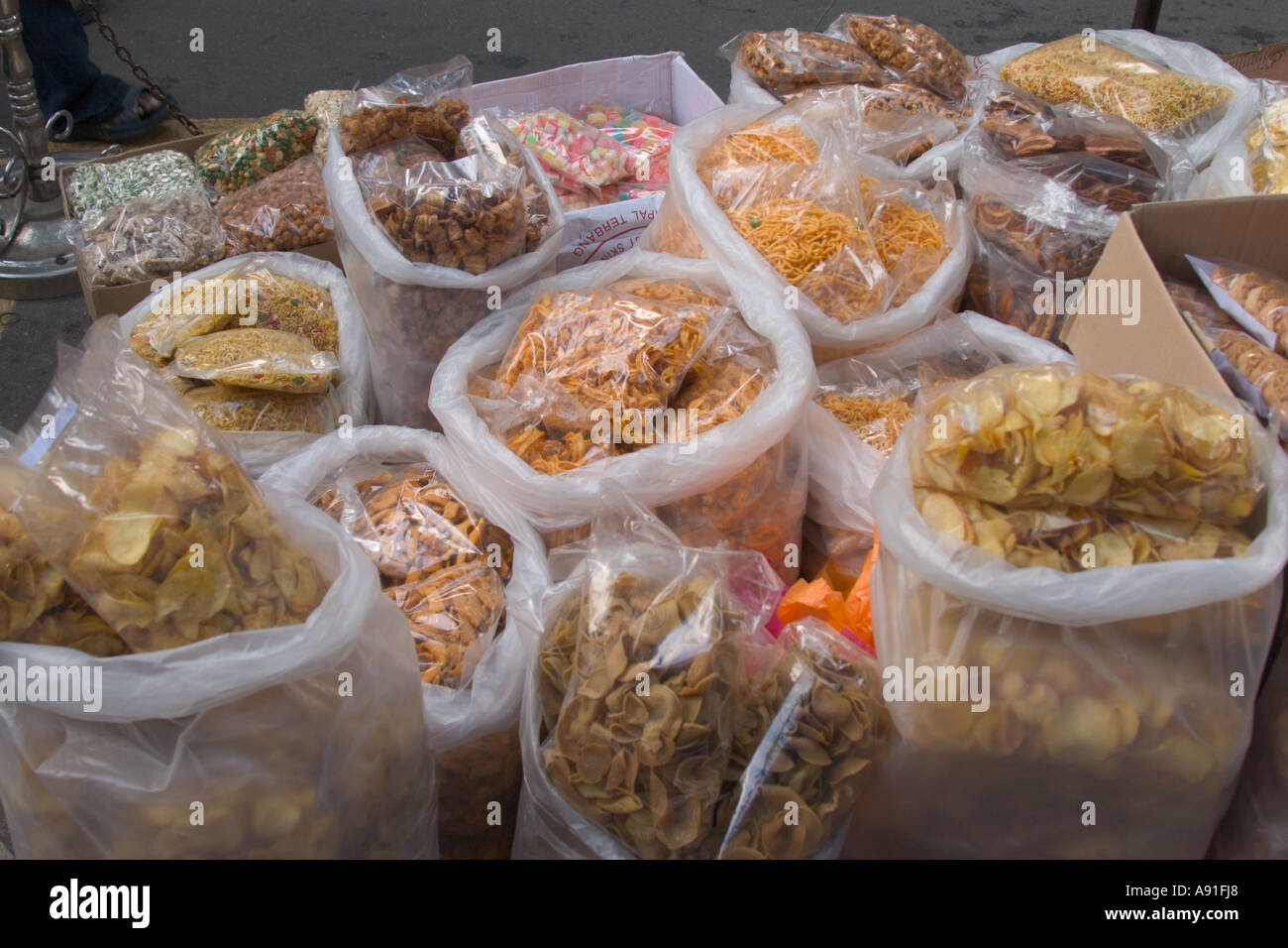 malaysian indian snacks, nuts, crispies and chips in plastic packets at ...