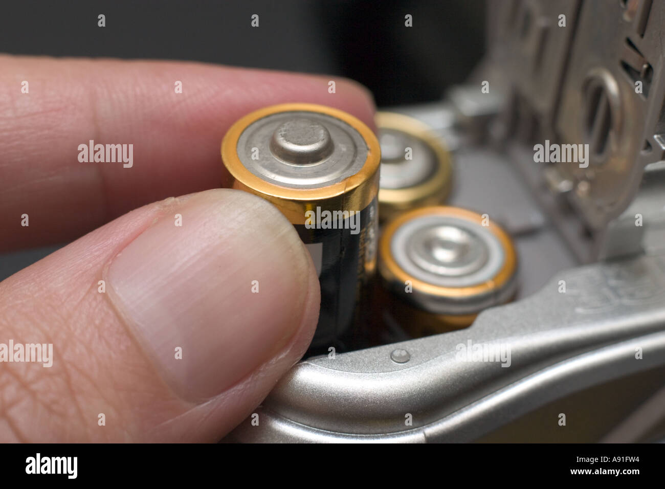 inserting battery into camera Stock Photo - Alamy