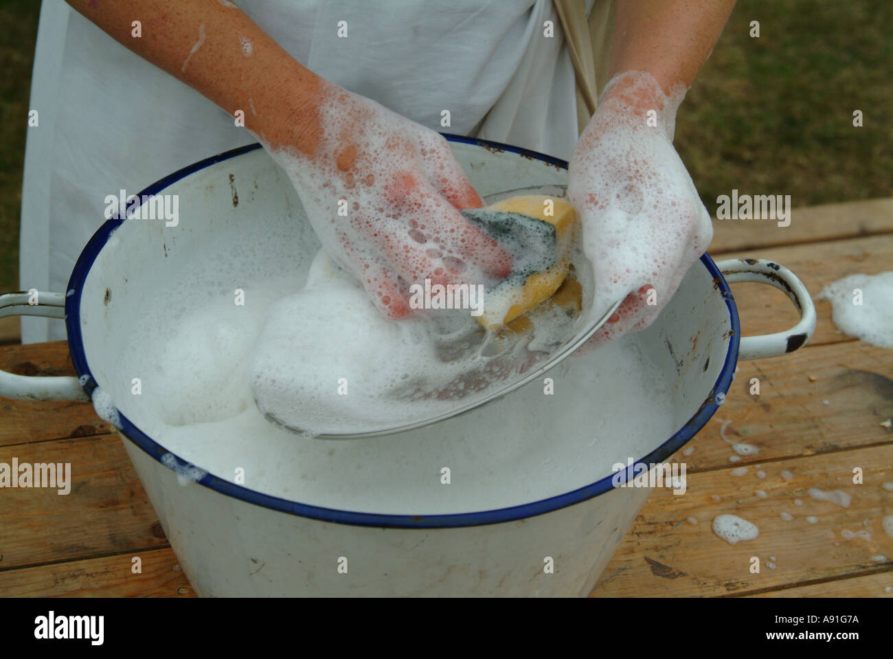 Woman washing plates Stock Photo - Alamy