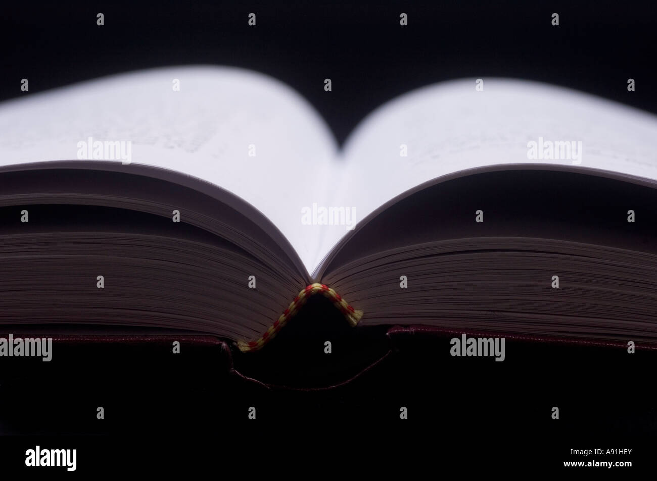 Close up of an open book against a black background Stock Photo - Alamy