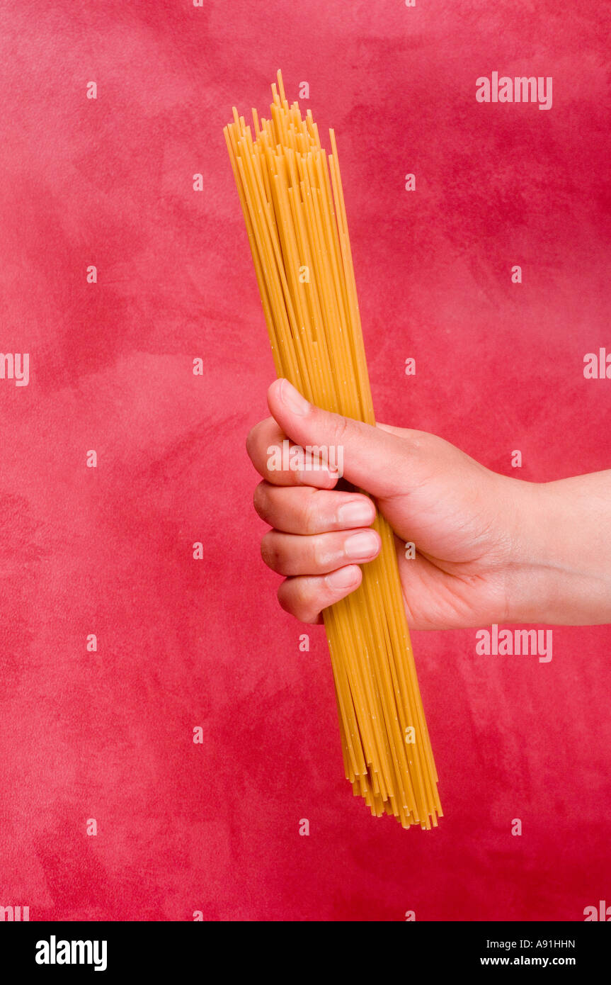 Hand holding Spaghetti Stock Photo - Alamy