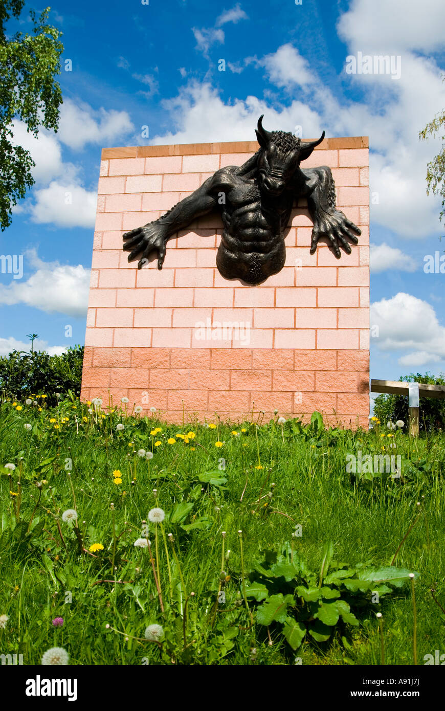 Statue of Bull trapped inside a wall Cheetham hill road Manchester UK ...