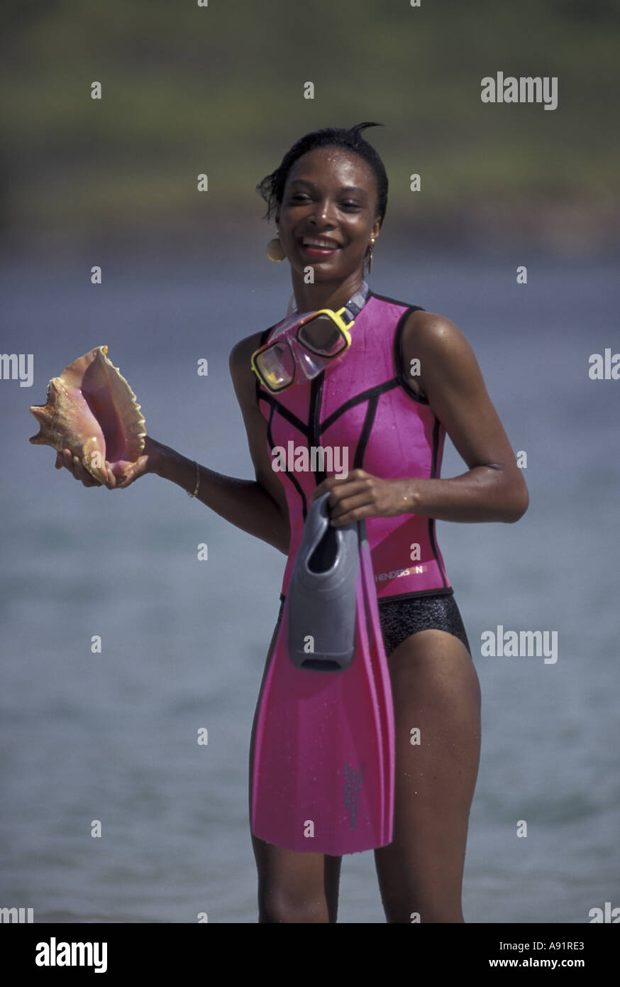 Caribbean woman holding conch shell hi-res stock photography and images ...