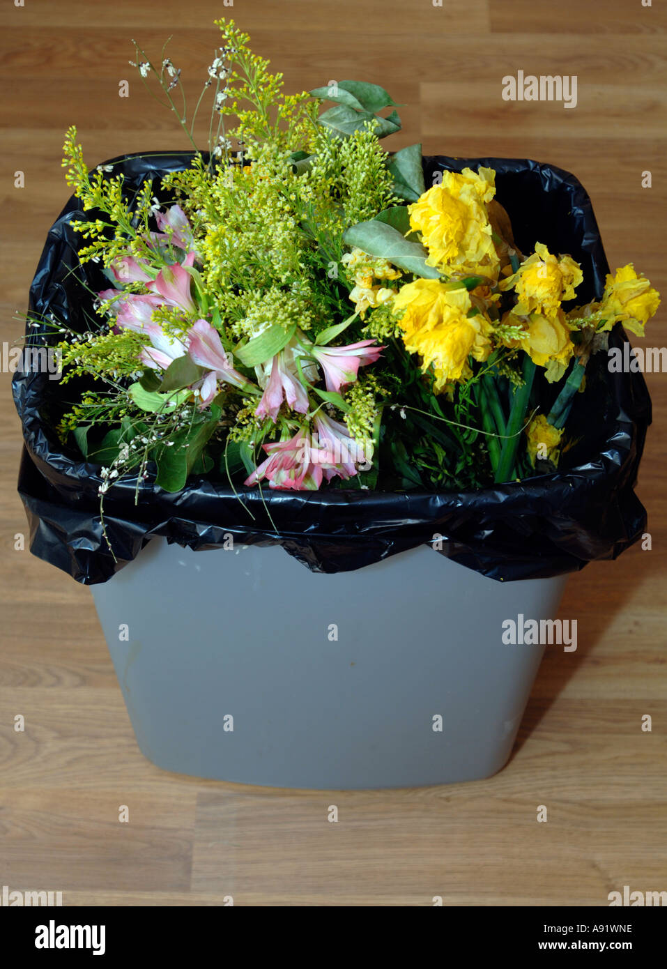 Flowers in rubbish bin Stock Photo - Alamy