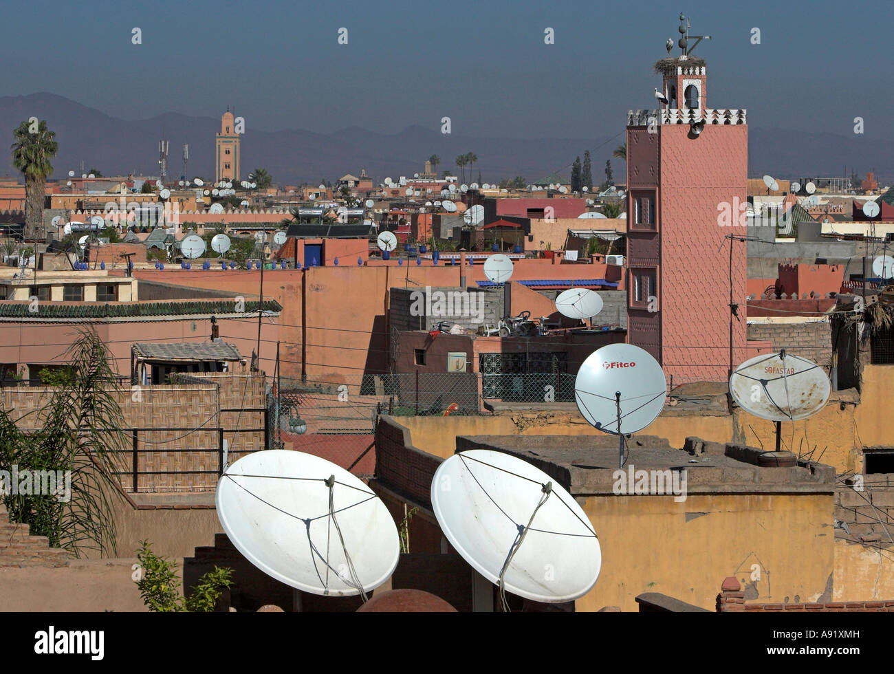 Mosque minarets and satellite television dishes Marrakech skyline ...