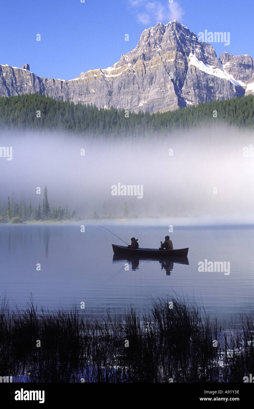 Canoe fishing Waterfowl Lake, Banff National Park, Canada Stock Photo ...