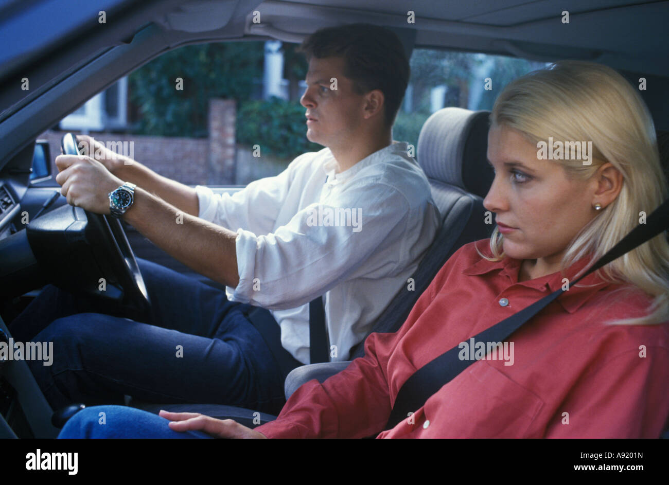 couple driving woman looking nervous Stock Photo - Alamy