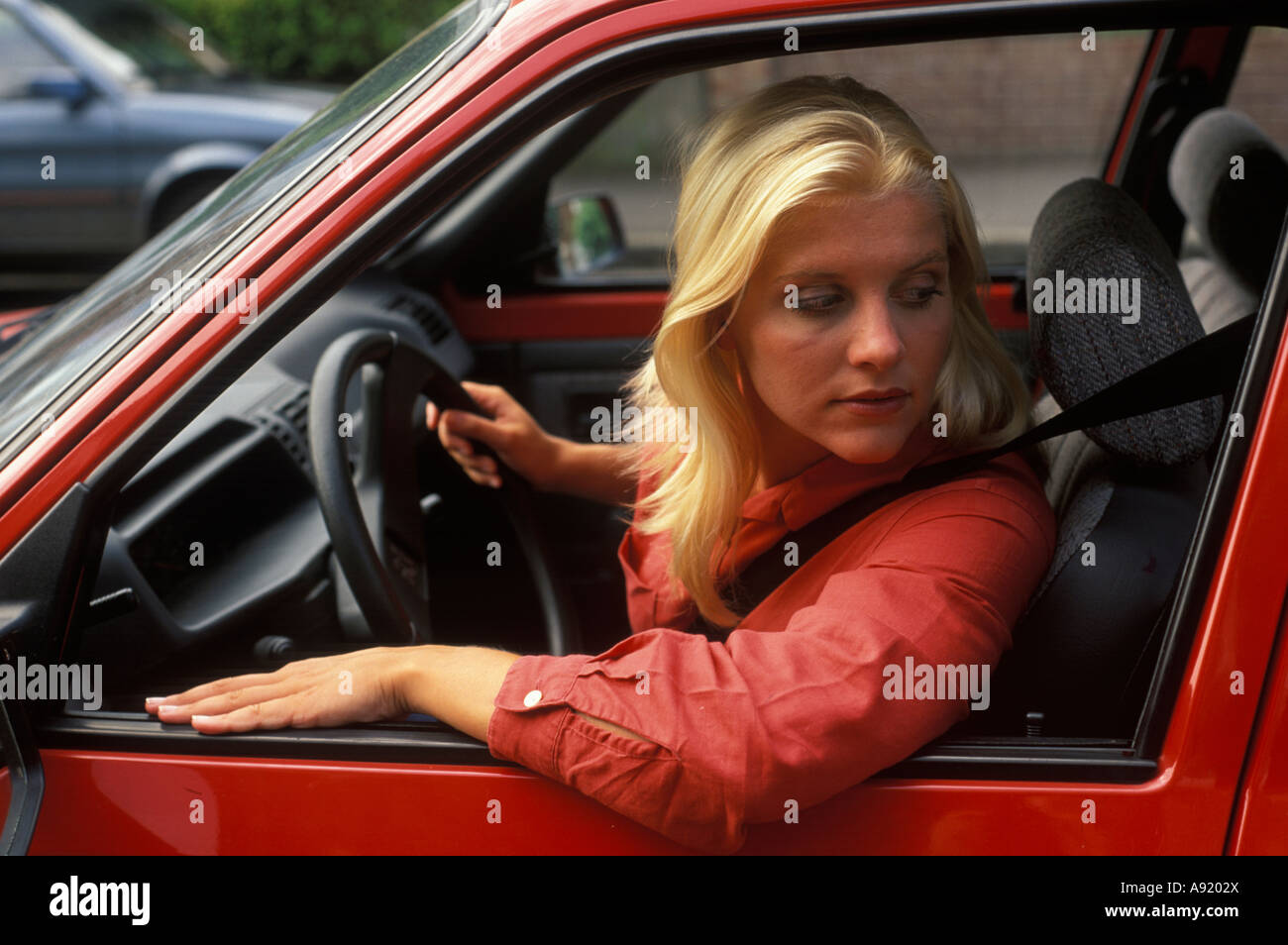 Woman driving reversing car looking hi-res stock photography and images ...