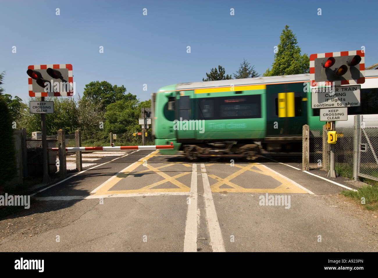 train passing a level crossing Stock Photo - Alamy