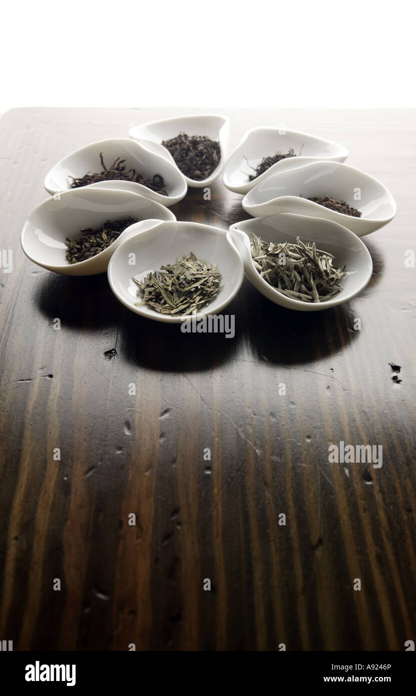 Different types of tea in vessels on a wooden counter Stock Photo - Alamy