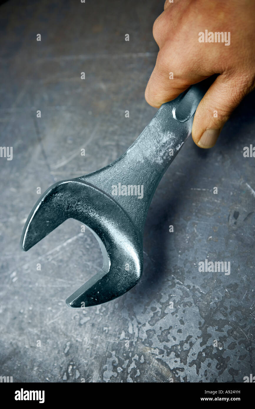 a hand with a tool - wrench Stock Photo - Alamy