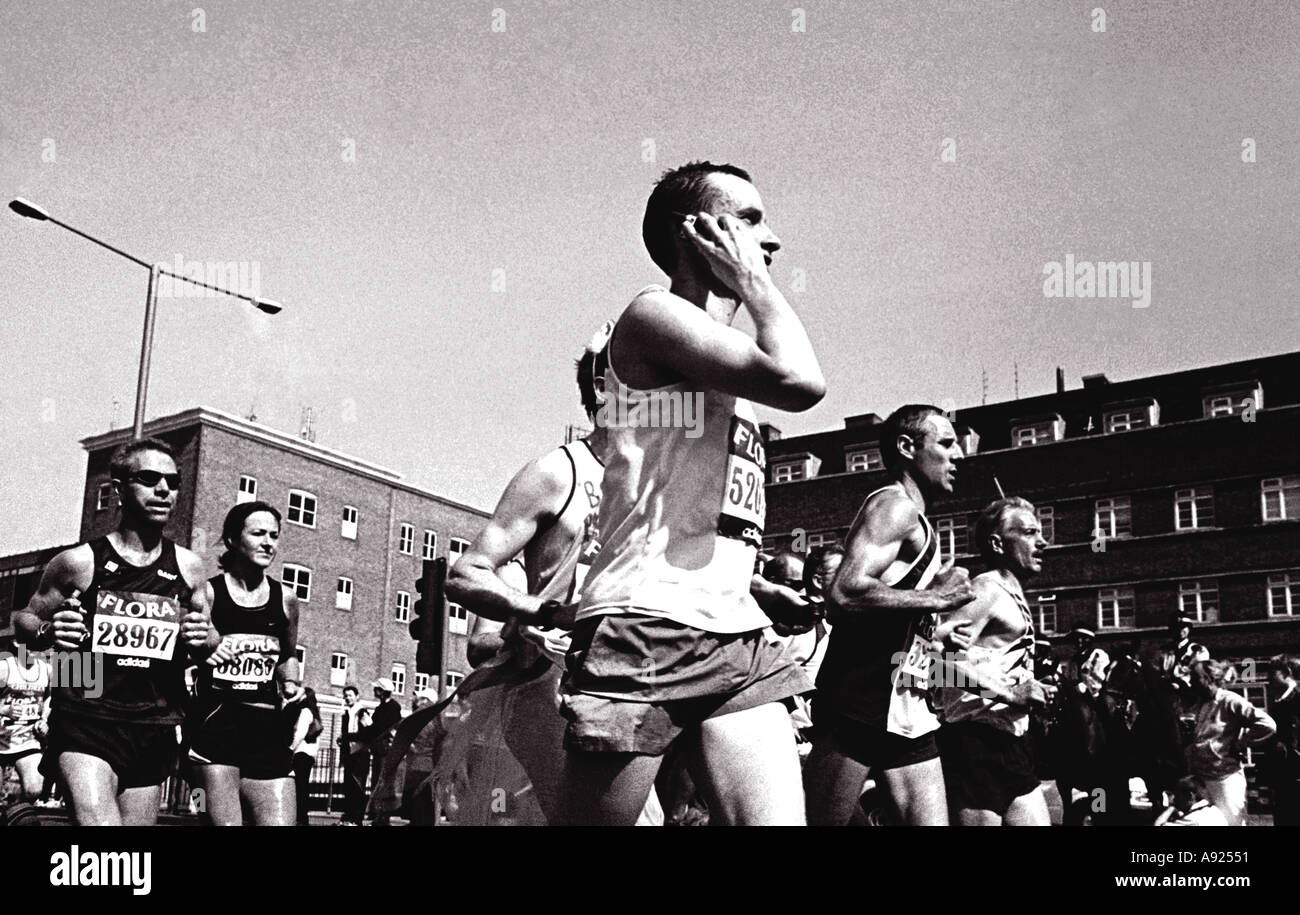 man talking on the phone while running in London marathon 2003 Stock ...