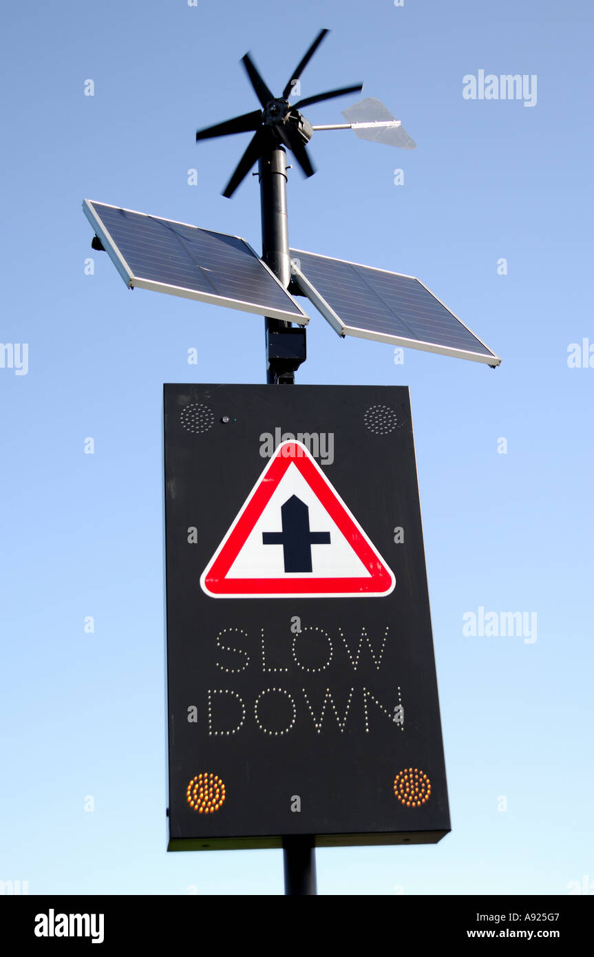 wind and solar powered roadsign showing flashing lights and 'Slow Down ...