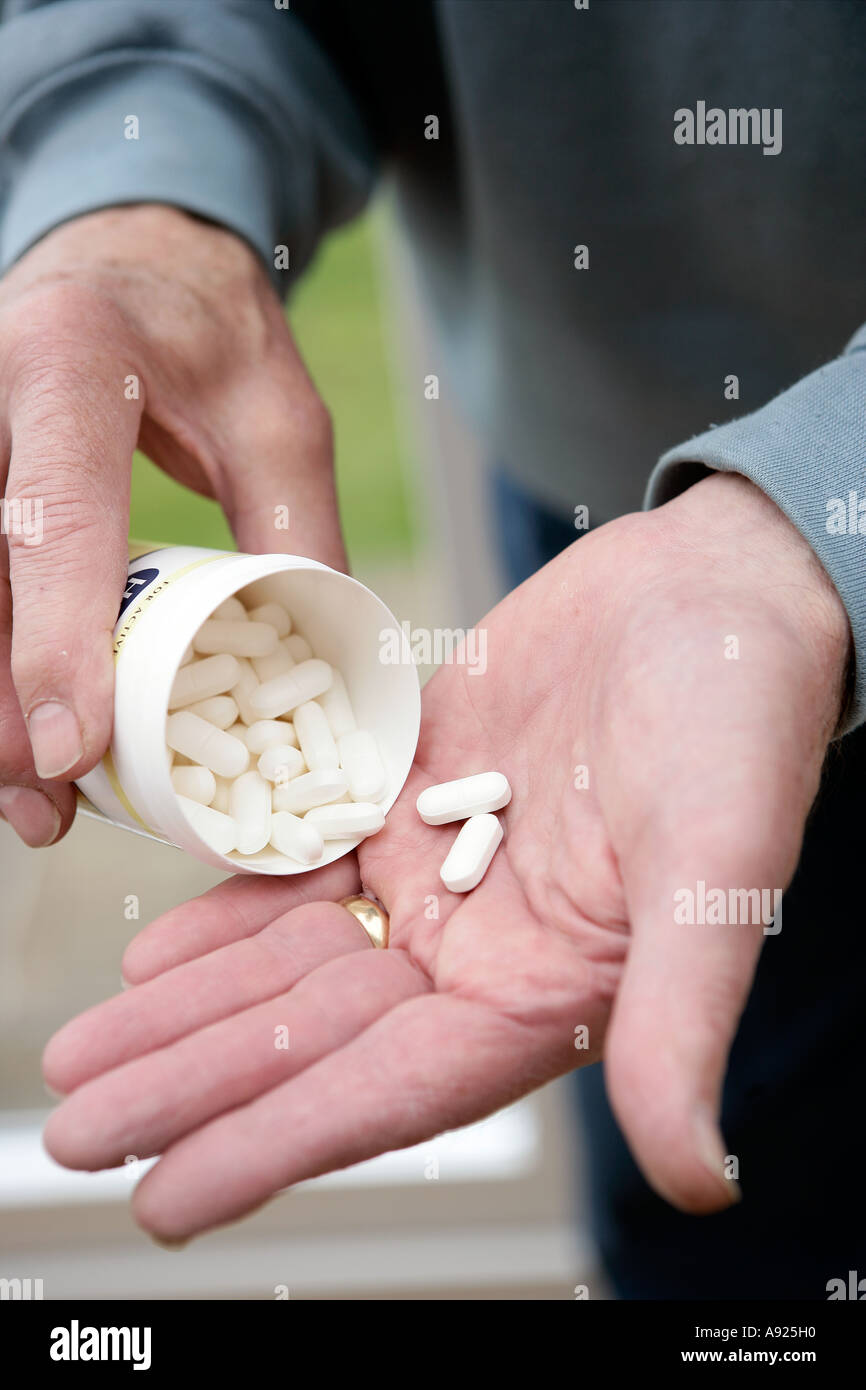 Supplement Tablets in Elderly Hands Stock Photo - Alamy