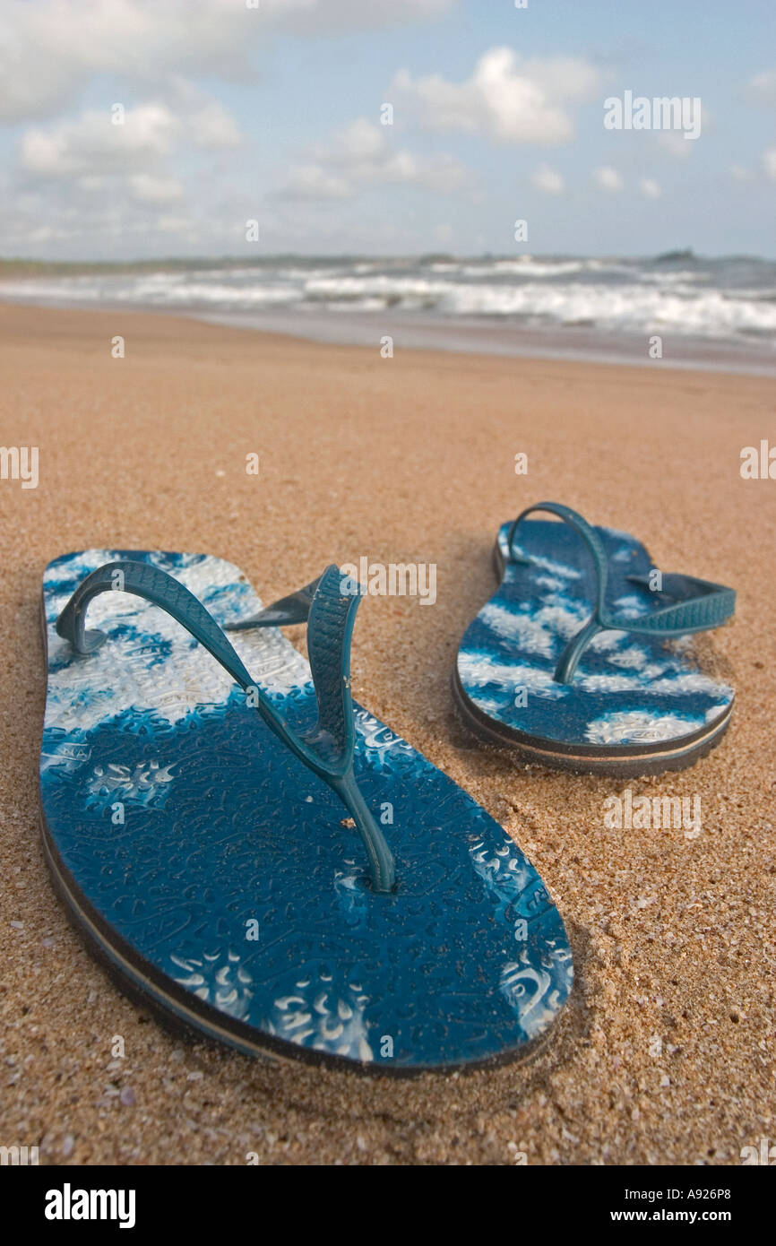 Blue rubber sandals on tropical beach Stock Photo - Alamy