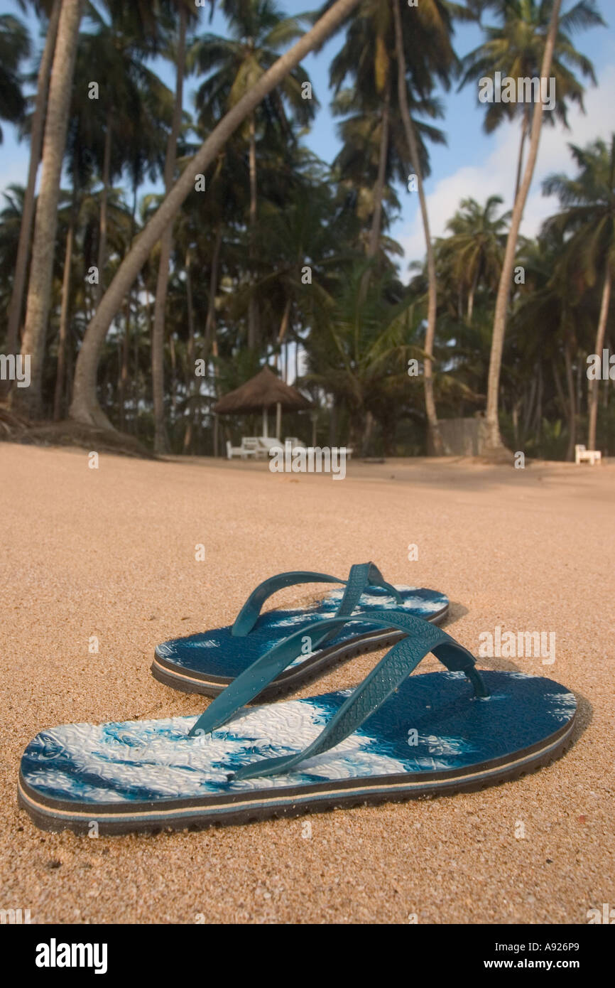 Blue rubber sandals on tropical beach Stock Photo - Alamy