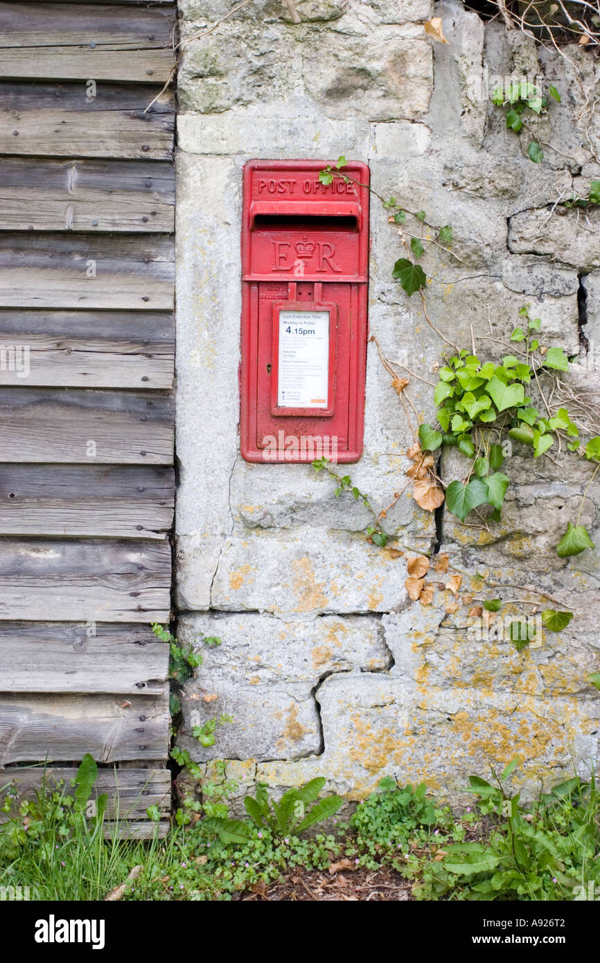 Postbox set in stone wall with timber cladding and ivy Stock Photo - Alamy