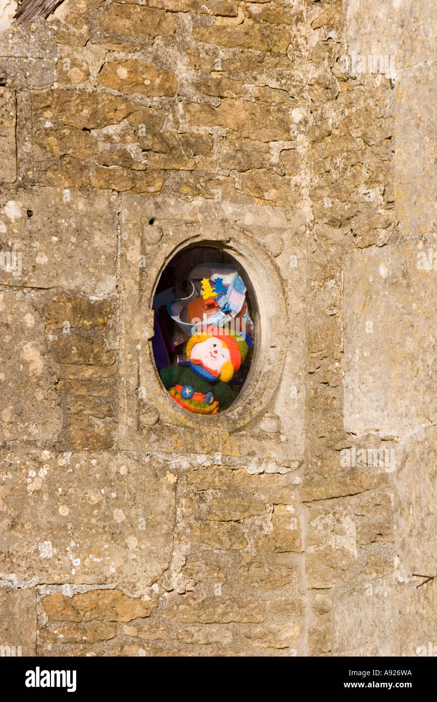 Cuddly toys in a round window Stock Photo - Alamy