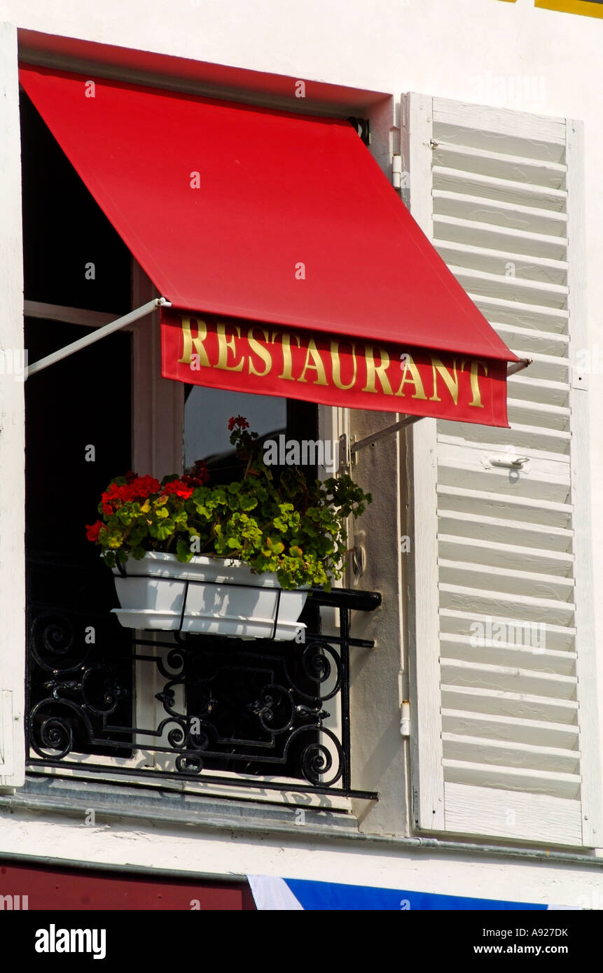 Red Fabric Canopy shades a balcony over a restaurant in the Place du ...