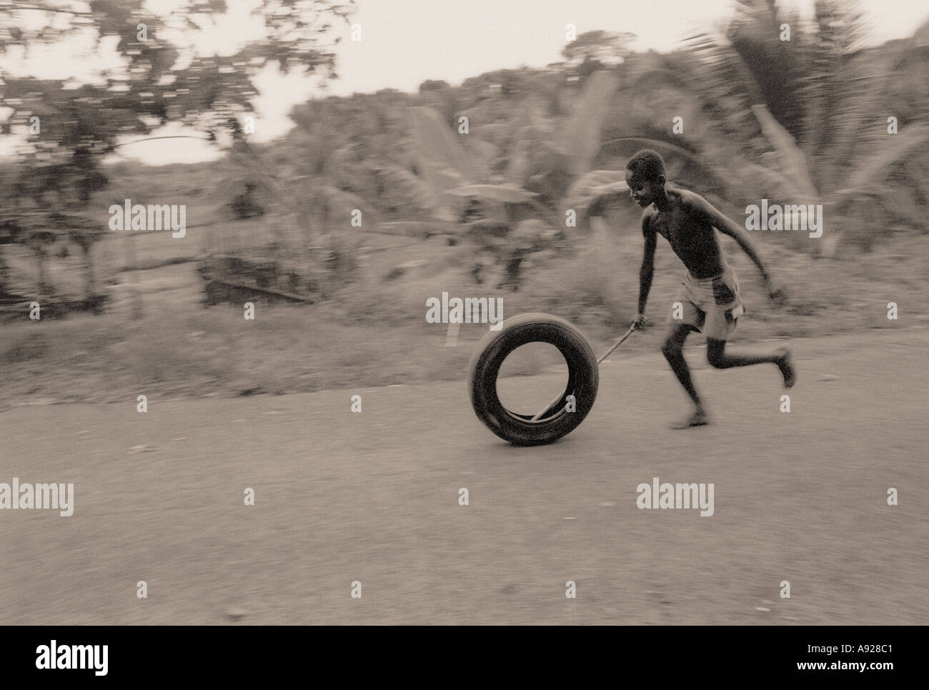 Child playing with car tyre Nosy Be Madagascar Stock Photo - Alamy