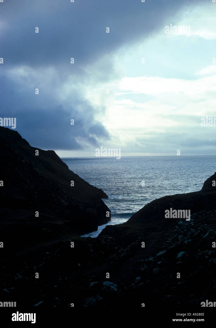 View through high cliffs of ocean and gray clouds on English coast ...