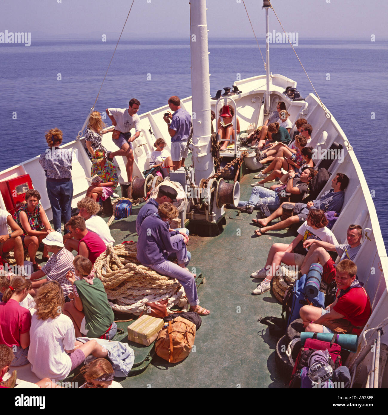 Young backpackers sitting on deck in the bows of an inter-island ferry ...