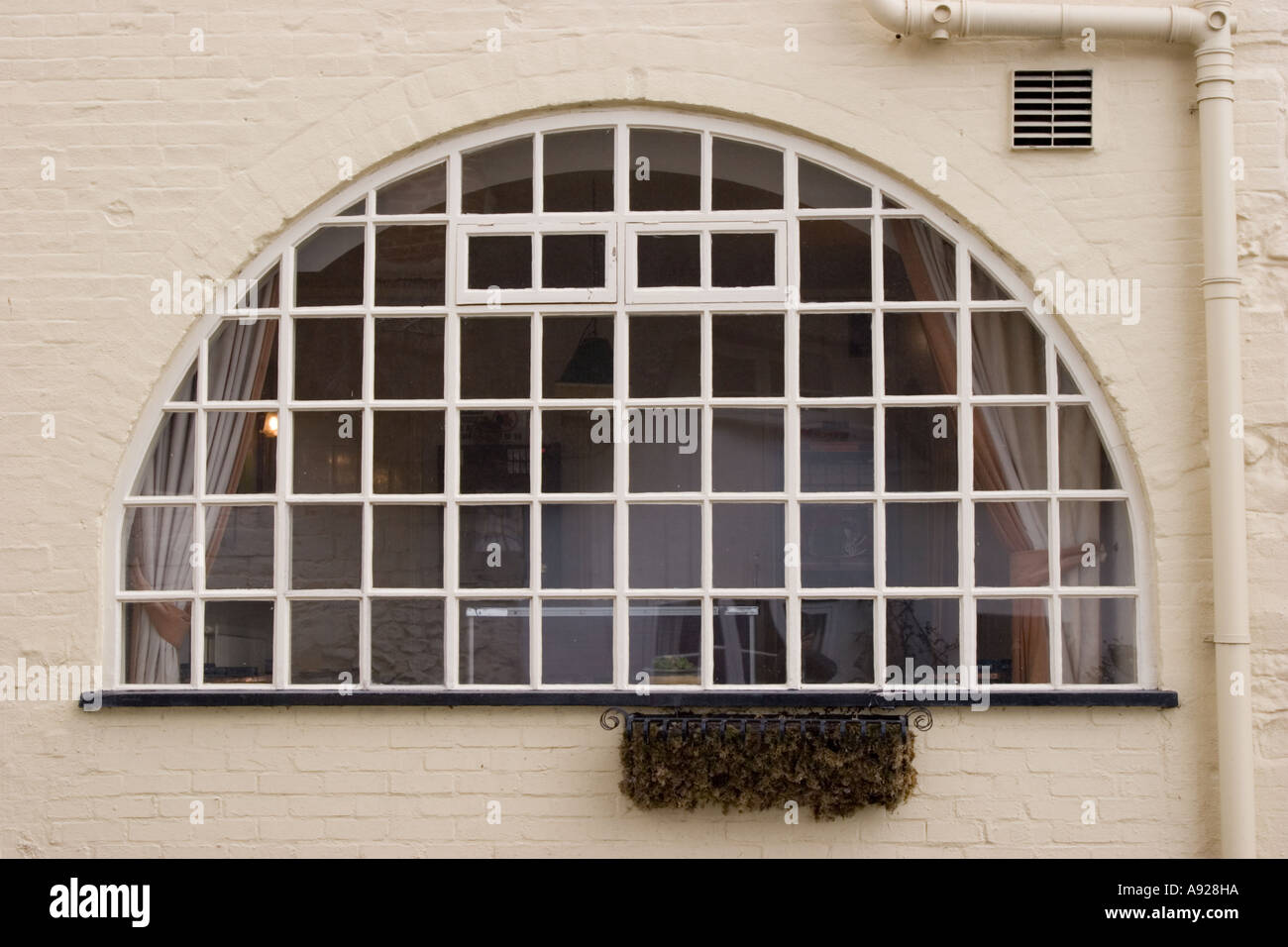 Interesting arched and multi paned pub window Stock Photo - Alamy