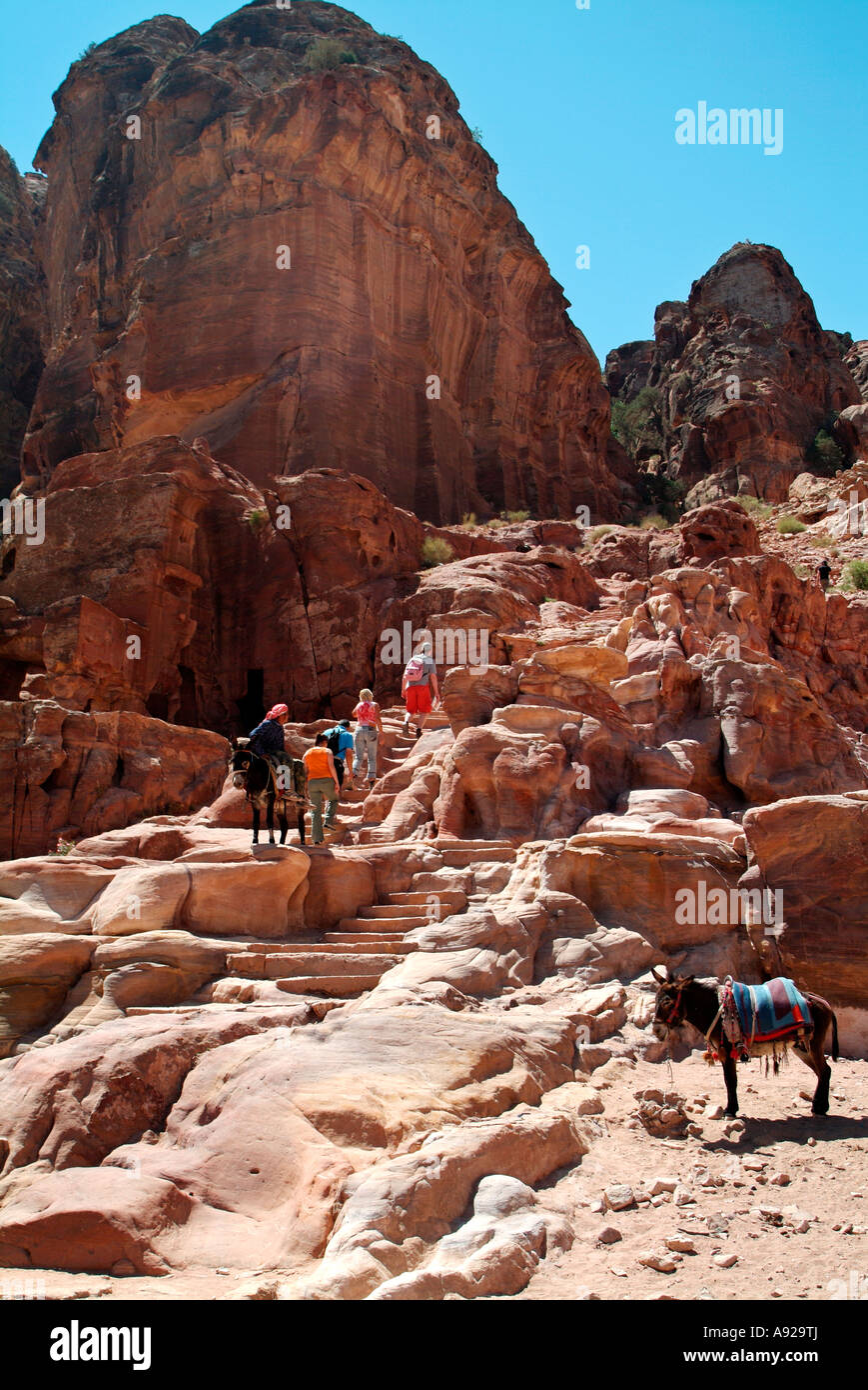 Tourists climbing steps leading to High Place at Petra in Jordan Stock ...