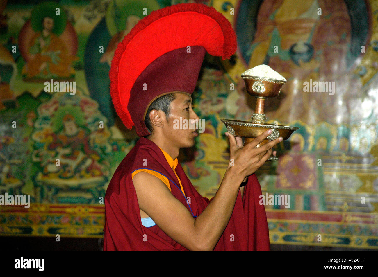 Portrait Buddhist monk of the red cap sect is wearing a specific red ...