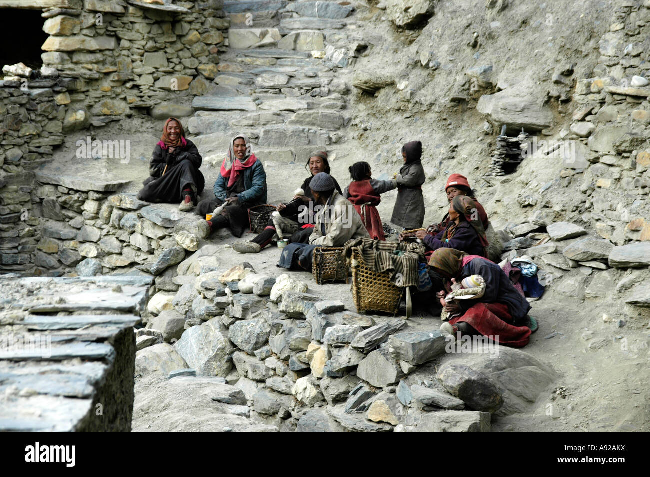 Group of women in traditional woolen dress are sitting on a wall Phu ...