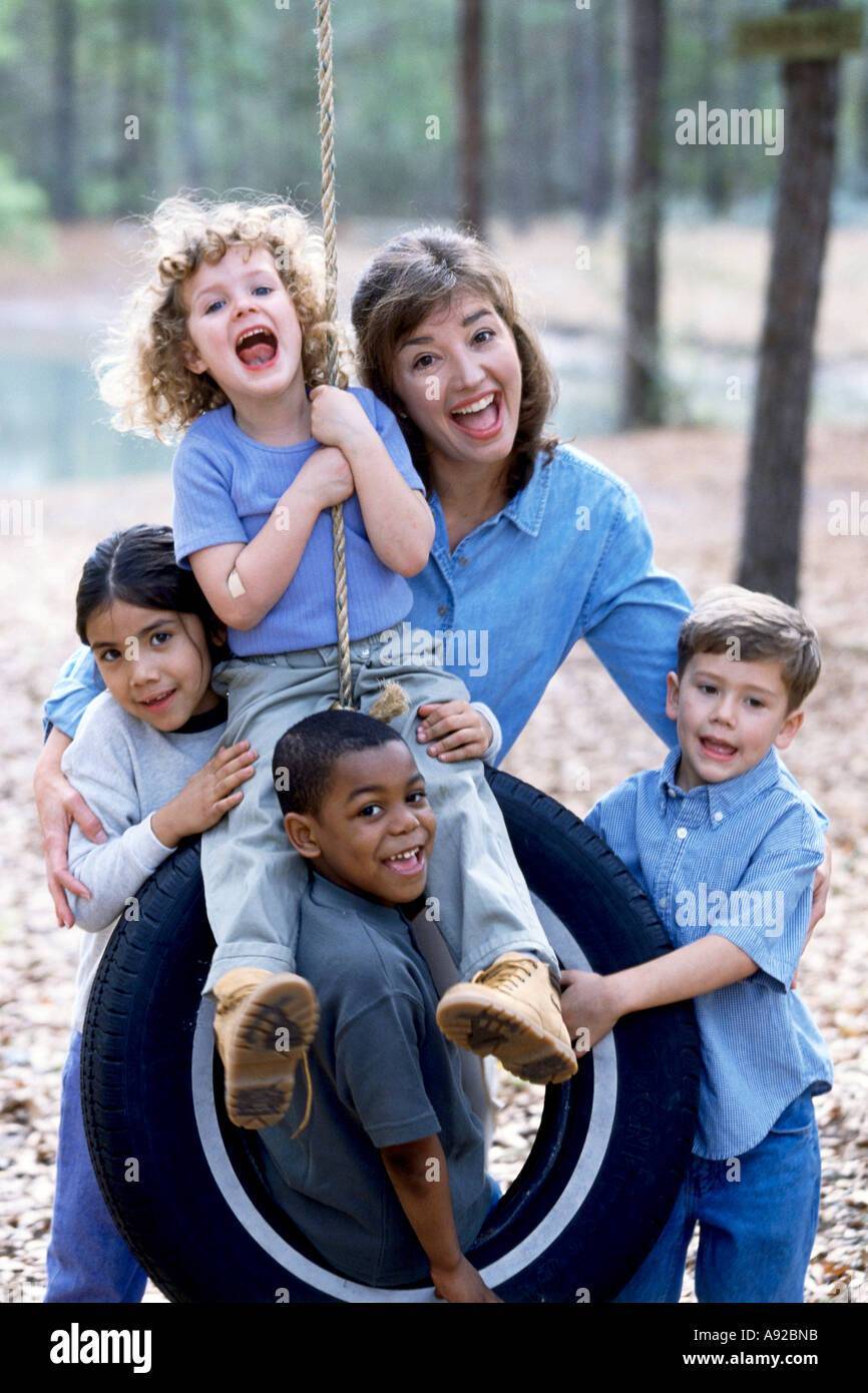 Four children sit stand the tree hi-res stock photography and images ...