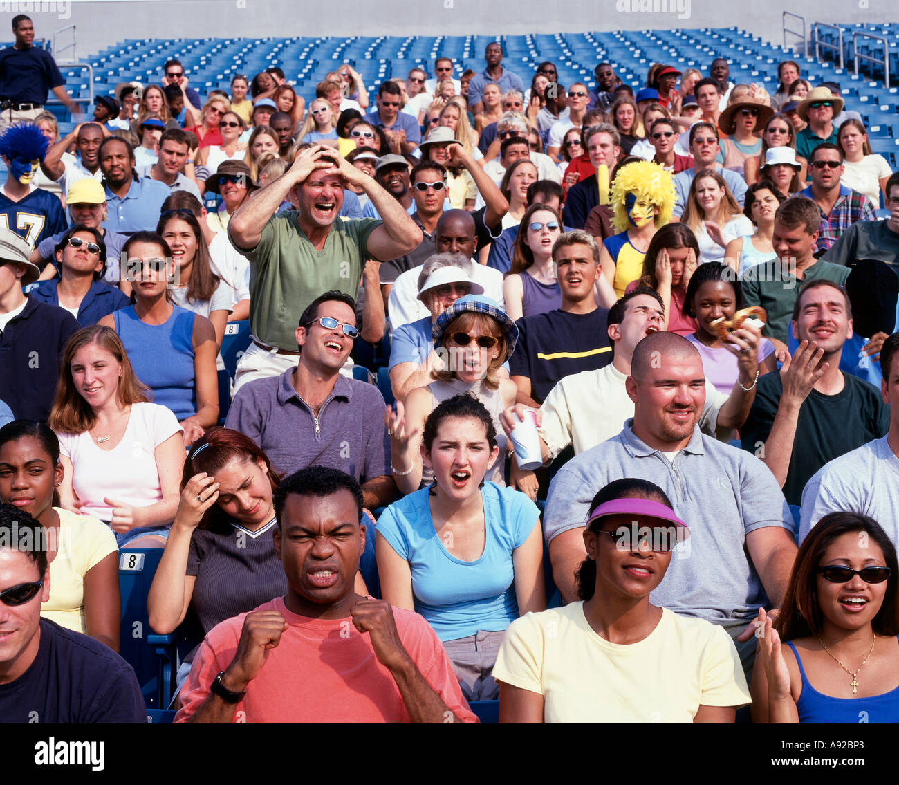 Group of spectators in a stadium cheering Stock Photo - Alamy
